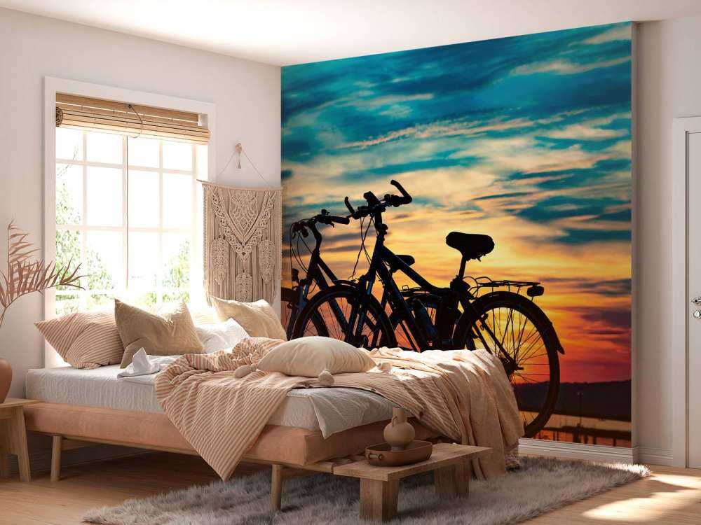 Fietsen bij zonsondergang - Fotobehang