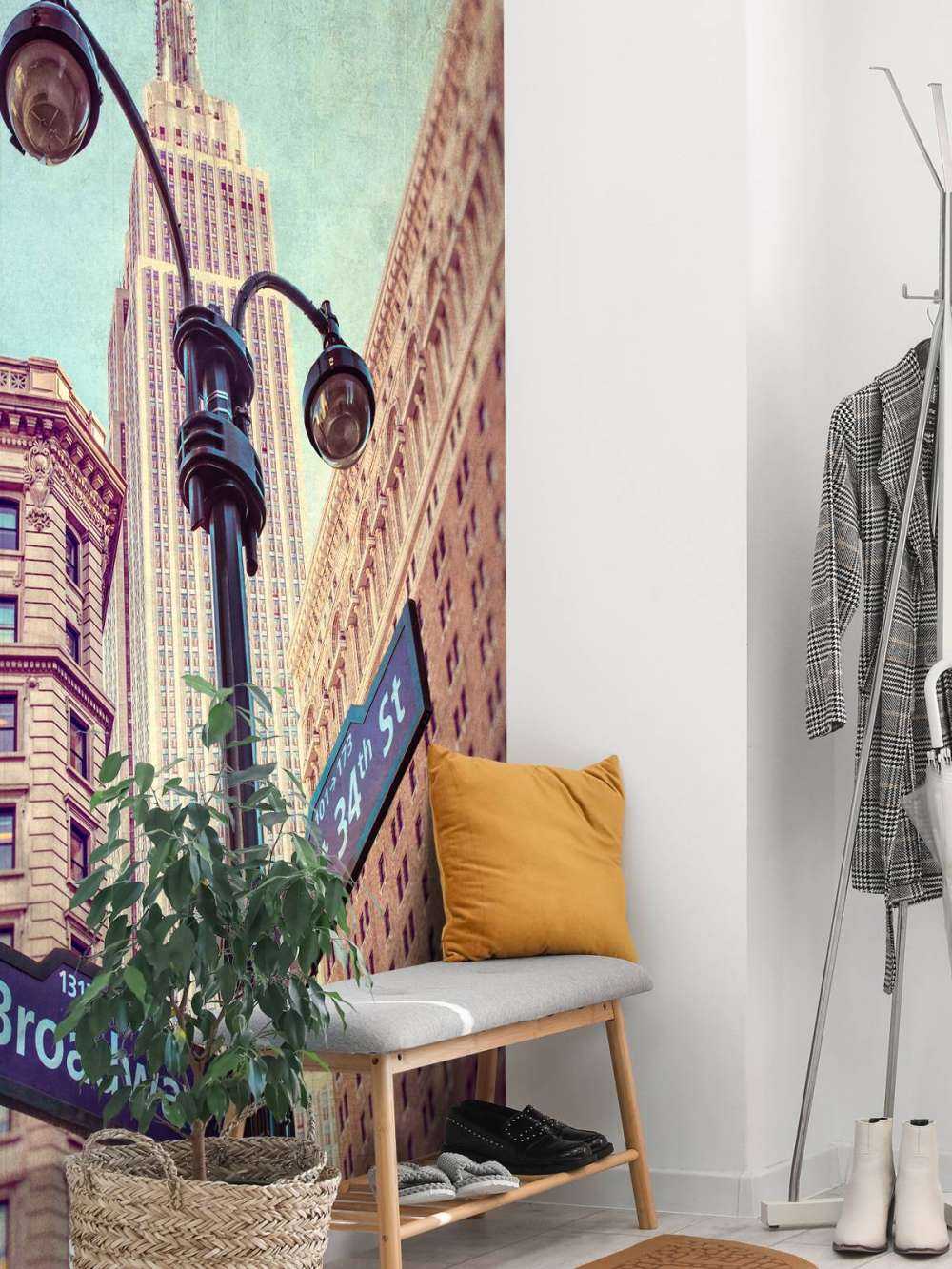 Street lamp and street signs with Empire State building in background ...